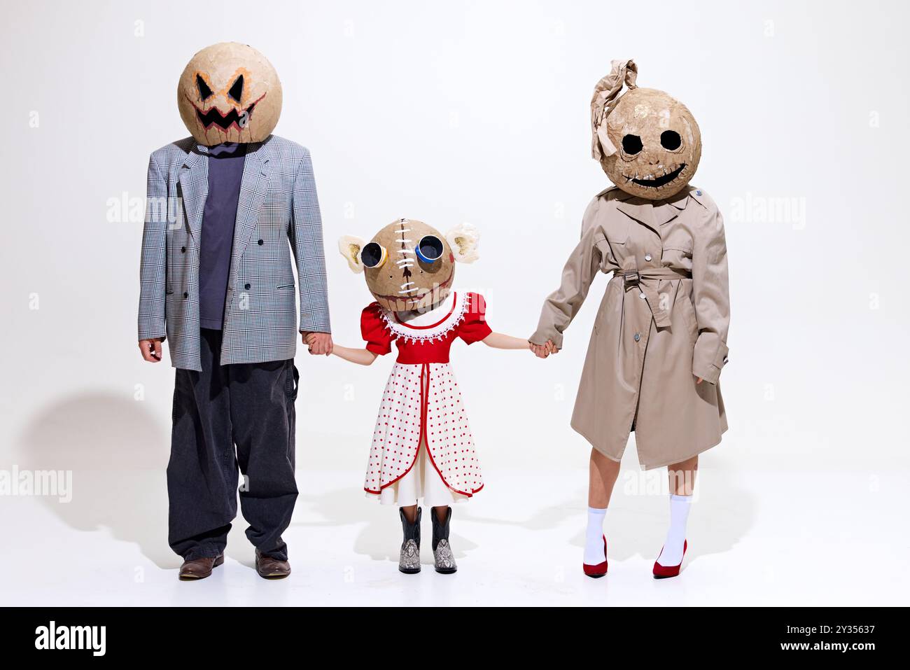 Creepy family wearing retro style costumes and masks isolated on white ...