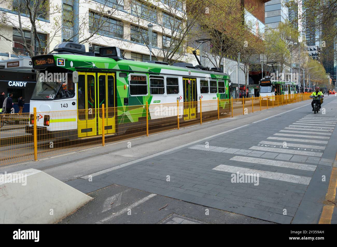 City trams on Swanston Street in the Melbourne CBD with a food delivery ...