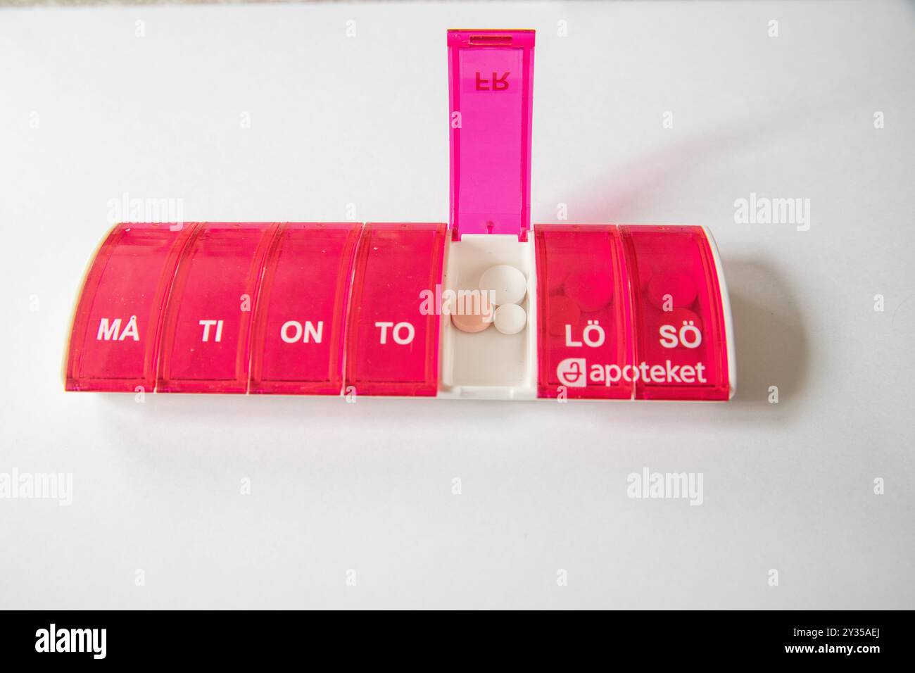 One week's daily doses of medicine are placed in weekly dose boxes ...