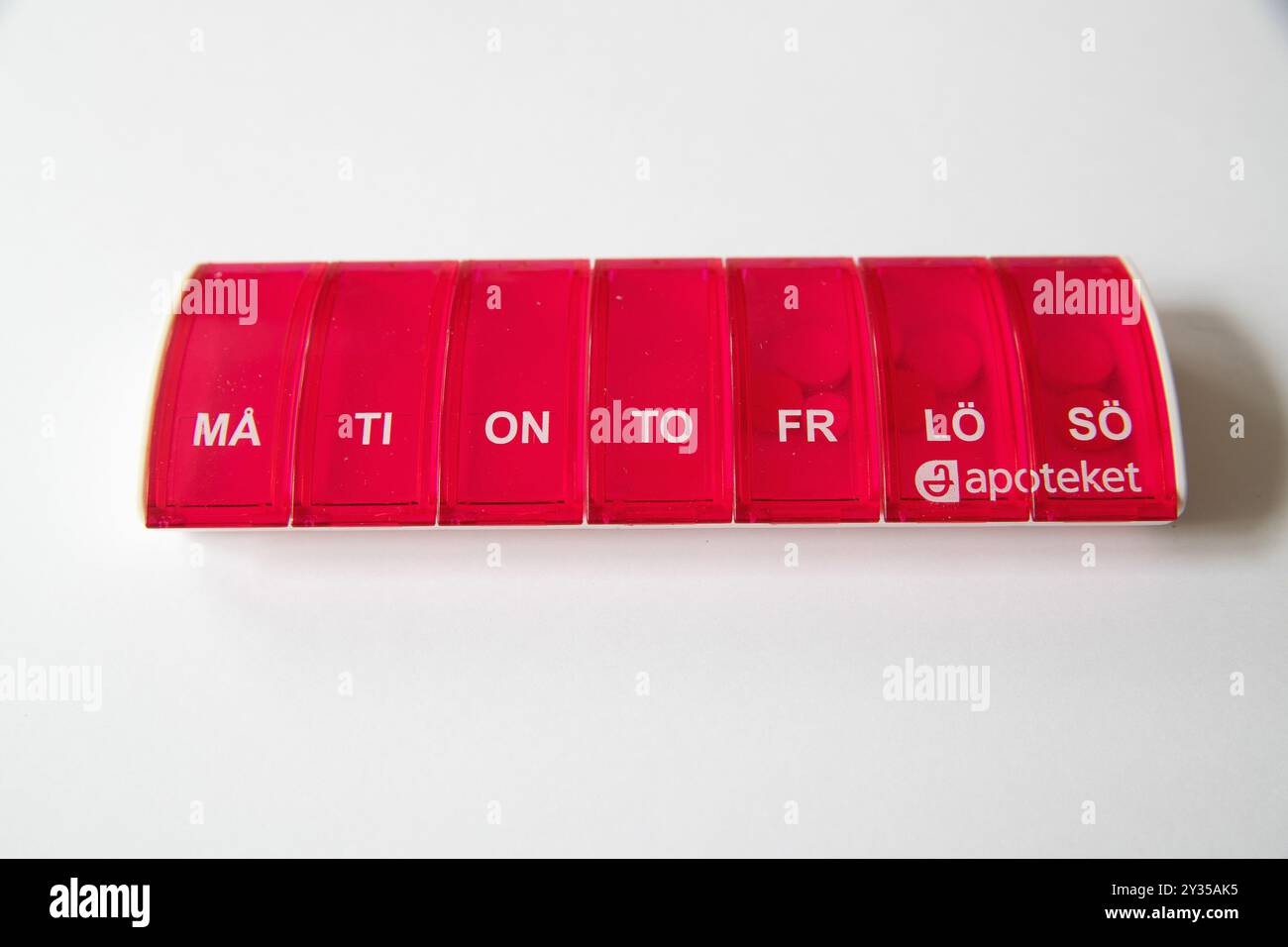 One week's daily doses of medicine are placed in weekly dose boxes ...