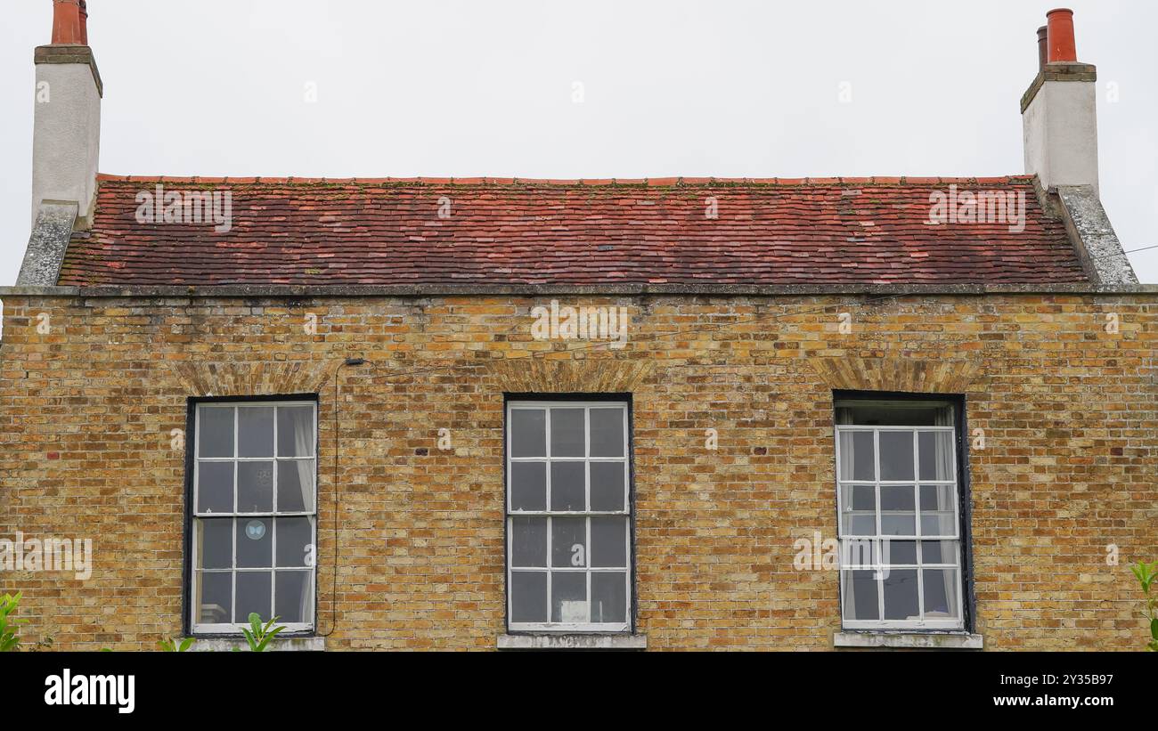 Traditional English house brick roofs, suburban area Stock Photo - Alamy