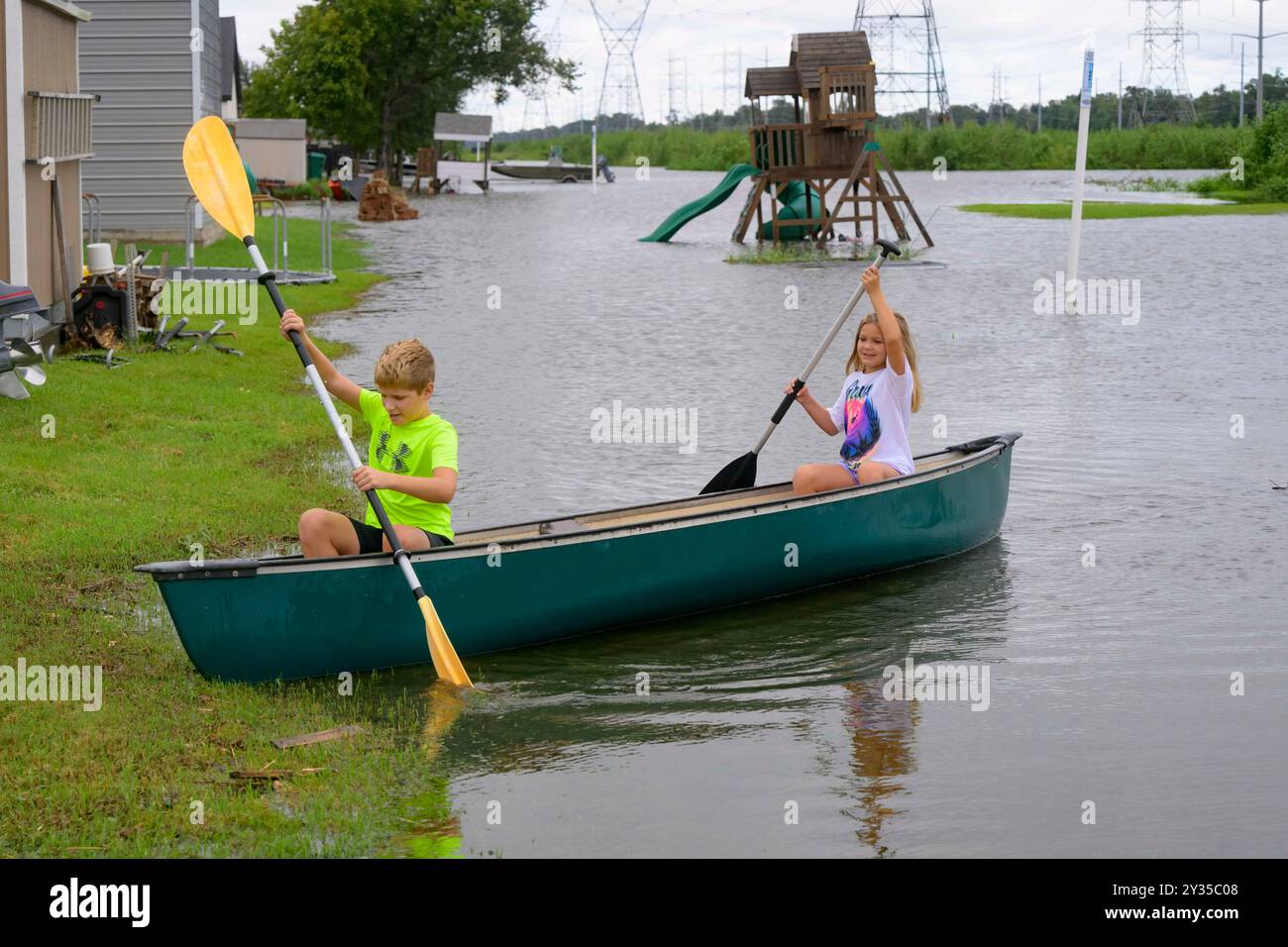 Siblings Avery, 10, and Grace LeBlanc, 7, canoe in their backyard next ...