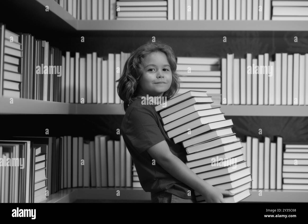 Hard working pupil. School kid with pile of books. Children enjoying ...