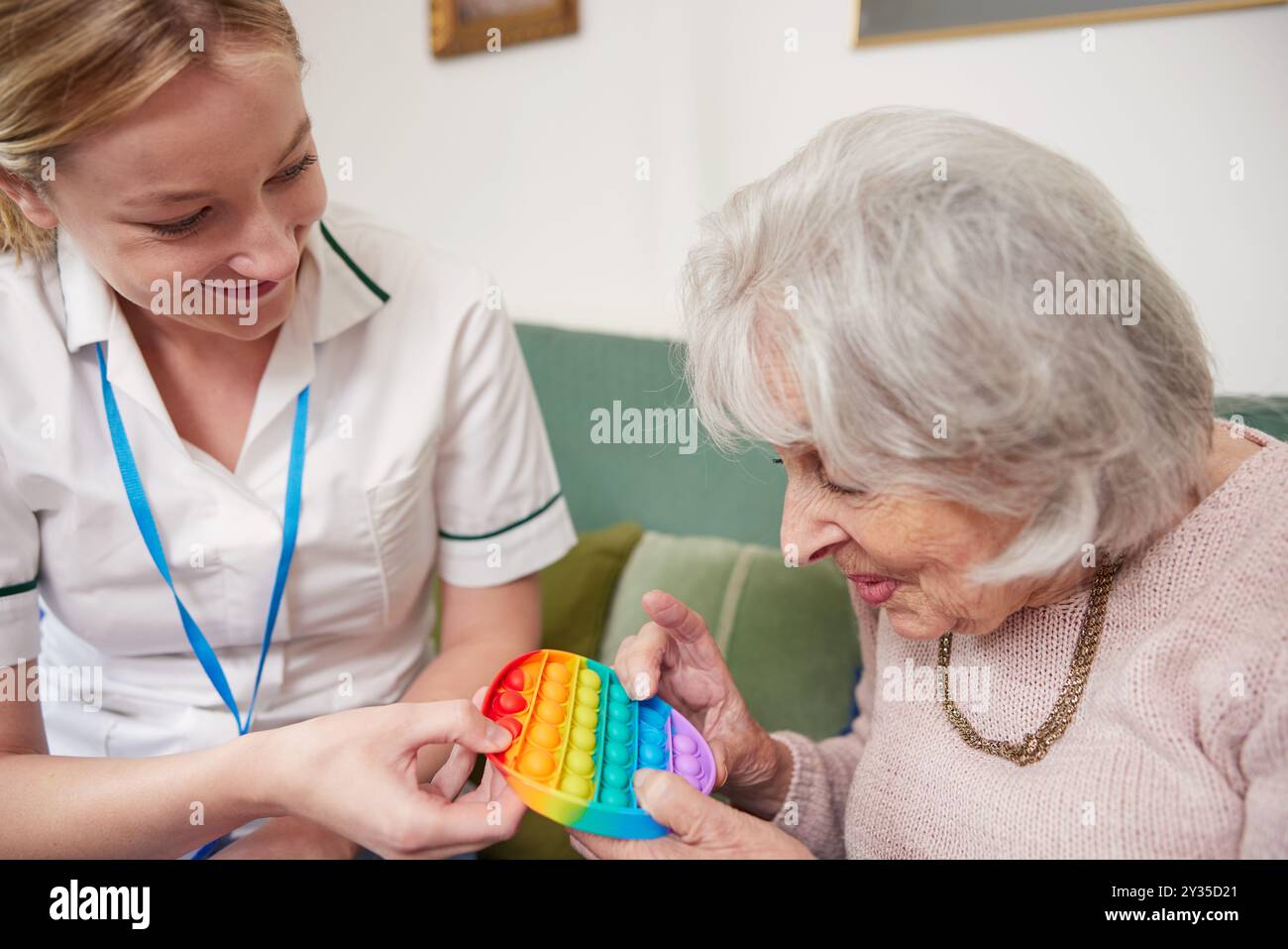 Female Physiotherapist Getting Senior Woman To Use Colourful Fidget Toy ...