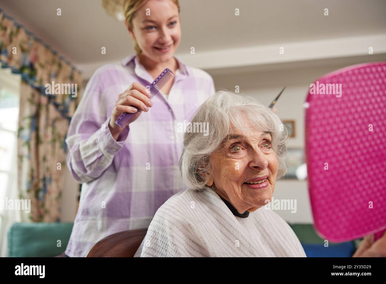 Female Mobile Hairdresser Cutting Senior Womans Hair At Home Stock ...