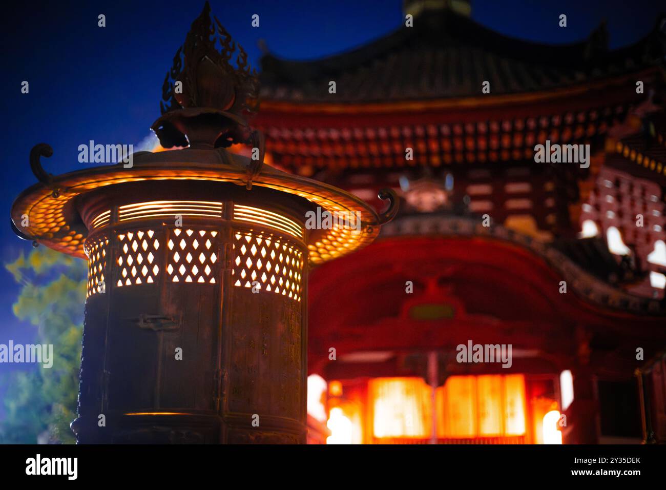 A traditional Japanese lantern with intricate design in front of a ...
