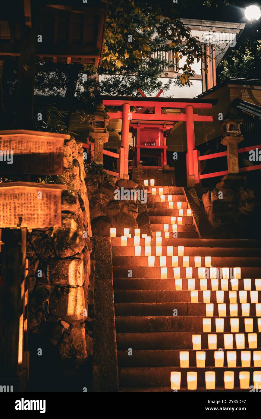 A beautifully lit pathway with candles leading up to a traditional ...