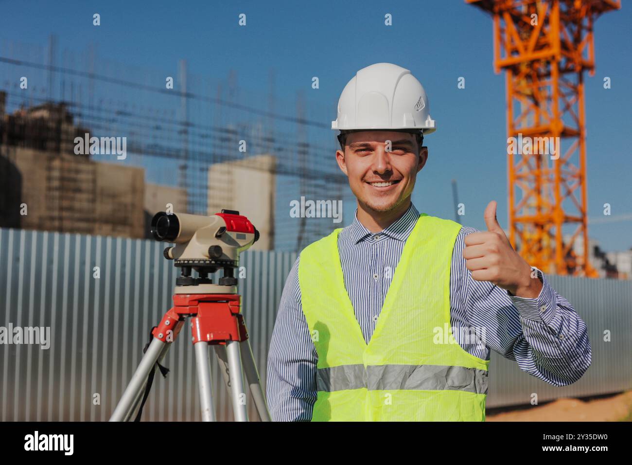 Happy engineer surveyor with survey camera showing thumbs up Stock ...