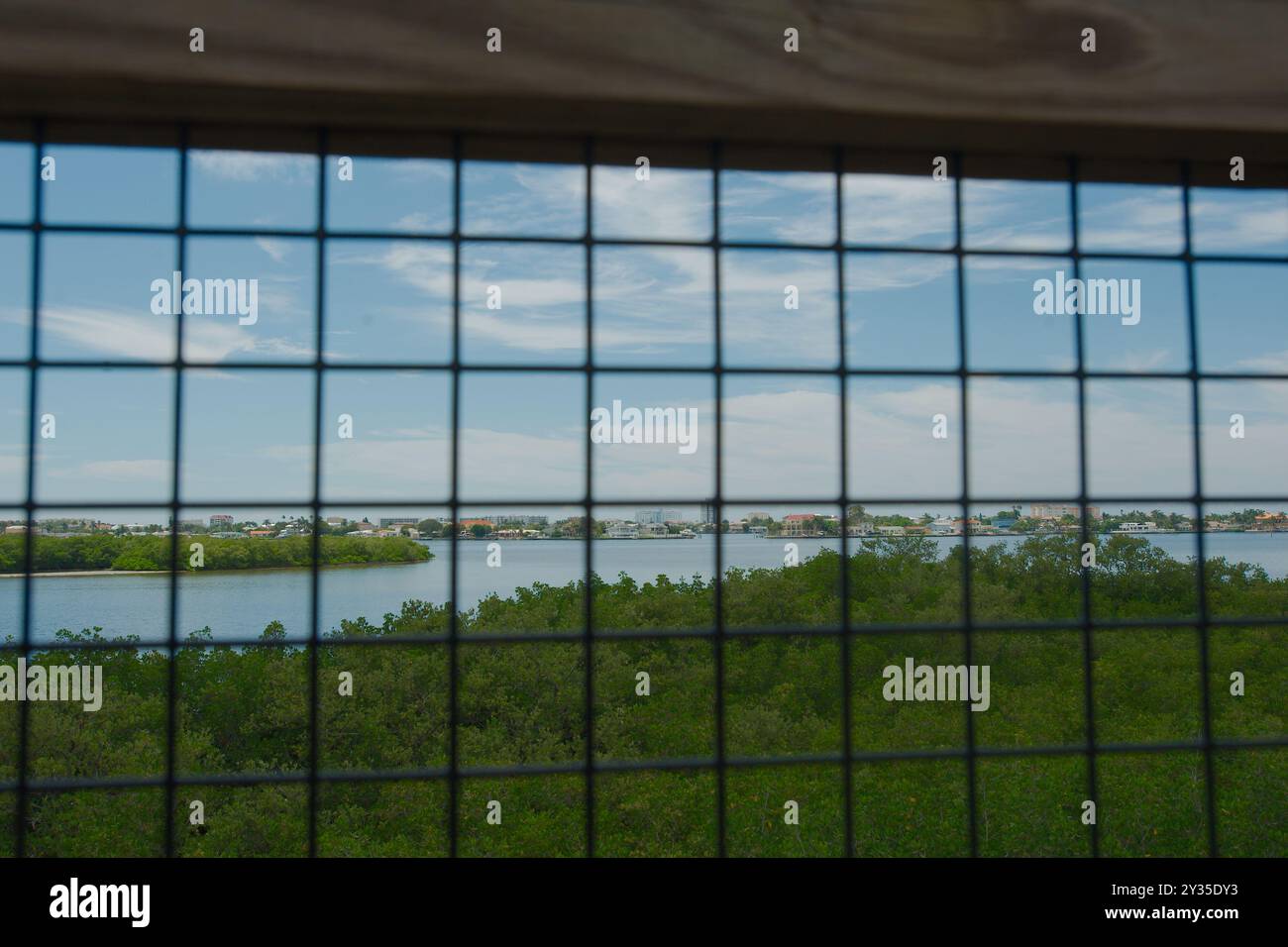 High Wide view frame through screen mesh from observation tower towards Boca Ciega Bay. Towards ...