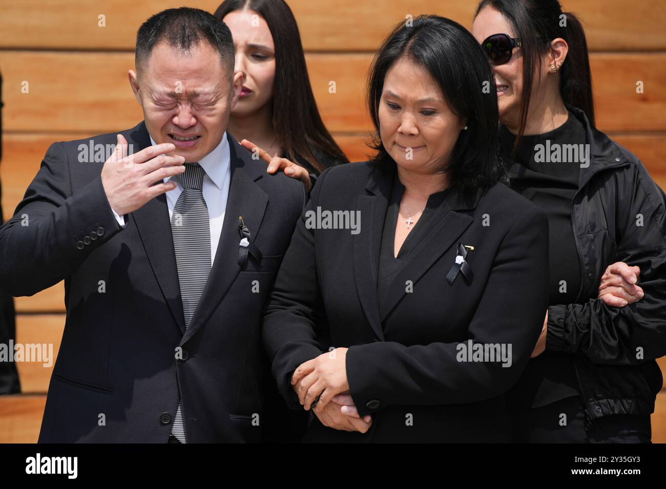 Keiko Fujimori, right, leaves her home with her brother Kenji as ...