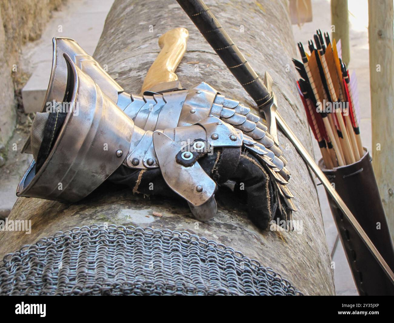 A knight in shining steel armor and leather gloves stands ready for ...