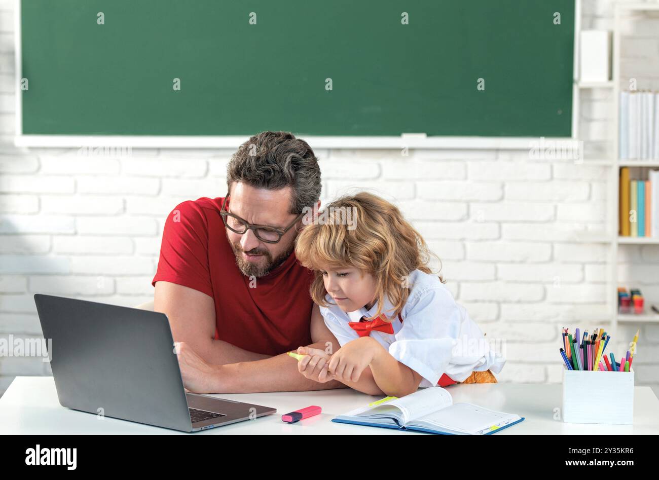 Kid boy learning with teacher. Funny little boy study with father in ...