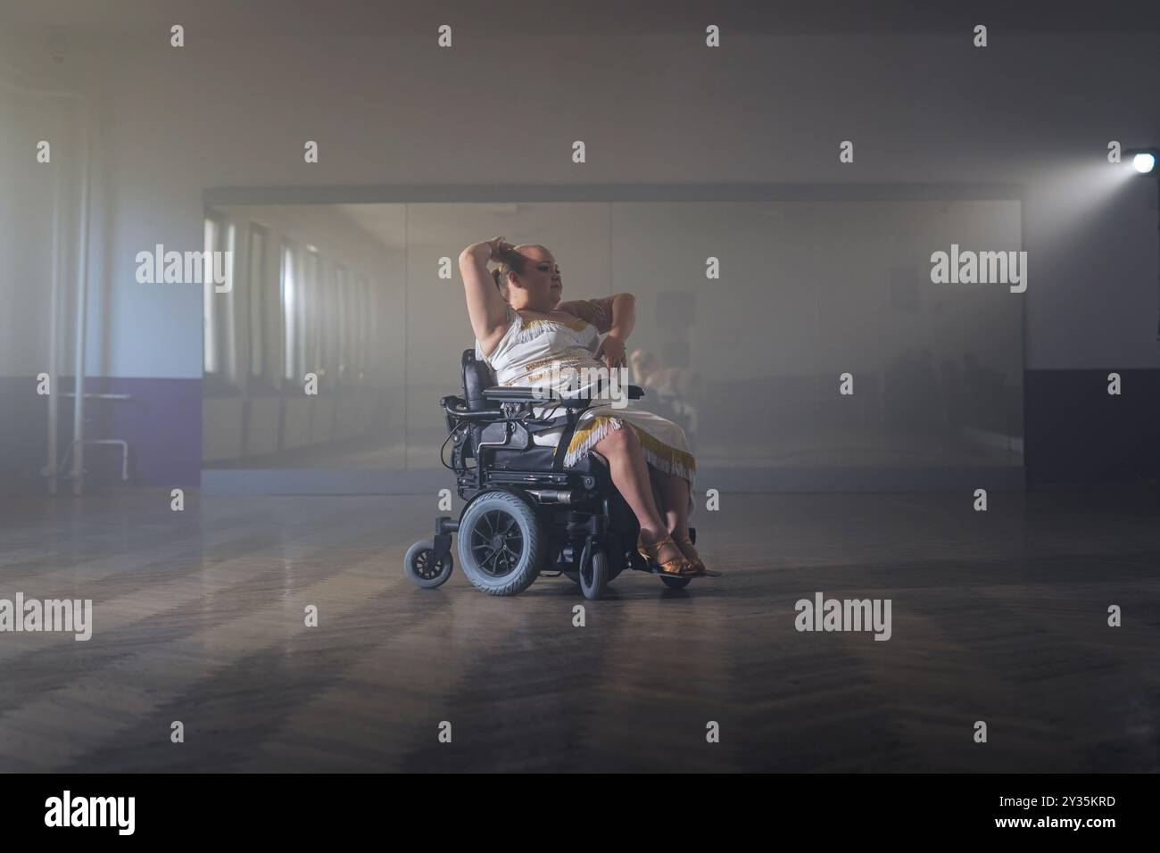 Elegant dressed-up woman with disability dancing in an electric ...
