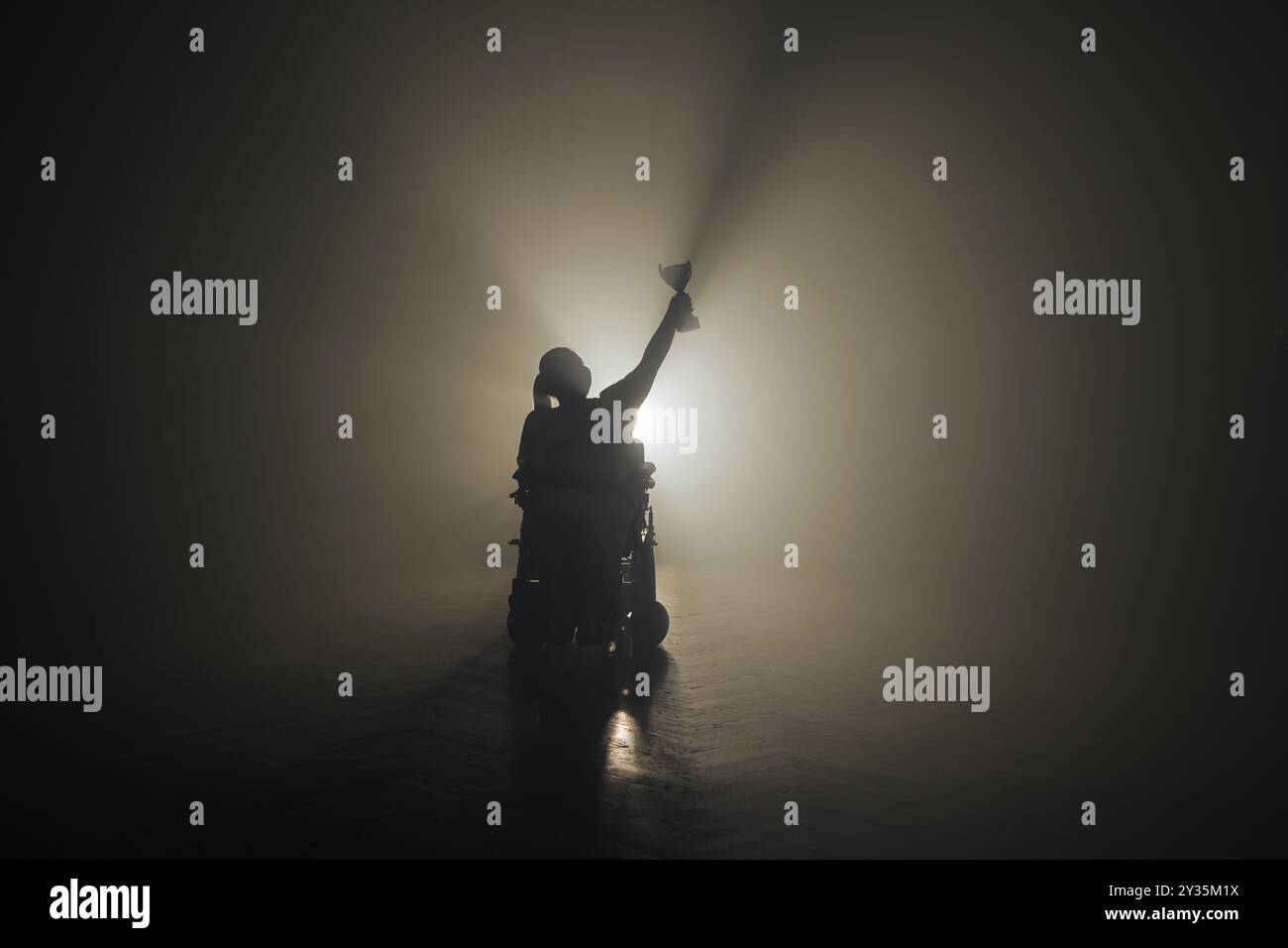 Woman with disability receiving a victory cup while sitting in a ...