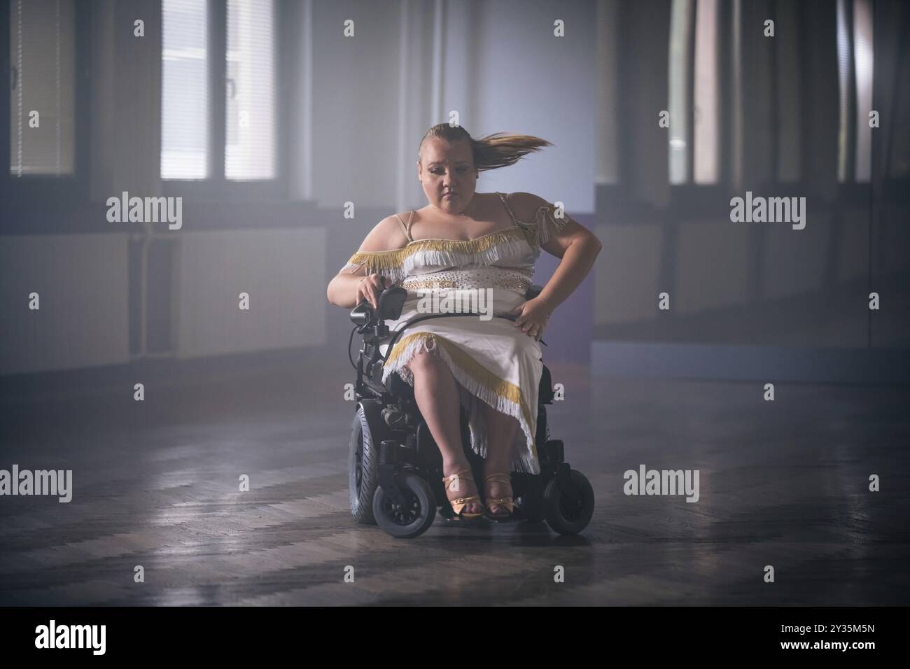 Woman practicing and performing a freestyle wheelchair dance at a ...