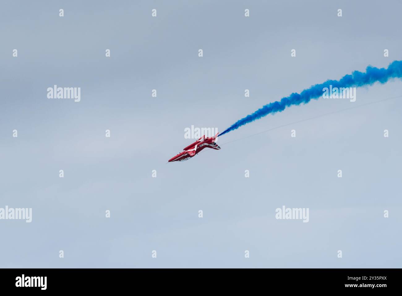 A single upside down Red Arrow emitting blue smoke at the Eastbourne ...
