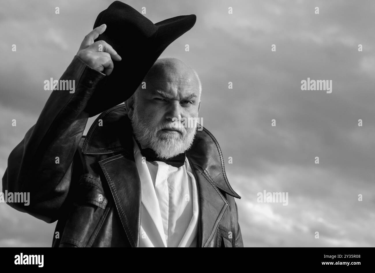 Gangster style. Fashion man in leather coat and hat outdoor. Cool gray ...