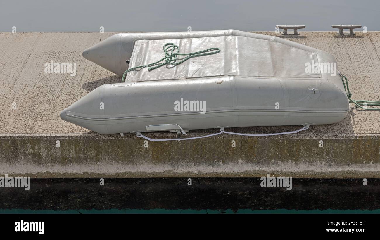 Up Side Down Small Rubber Dinghy Boat at Floating Dock Stock Photo - Alamy