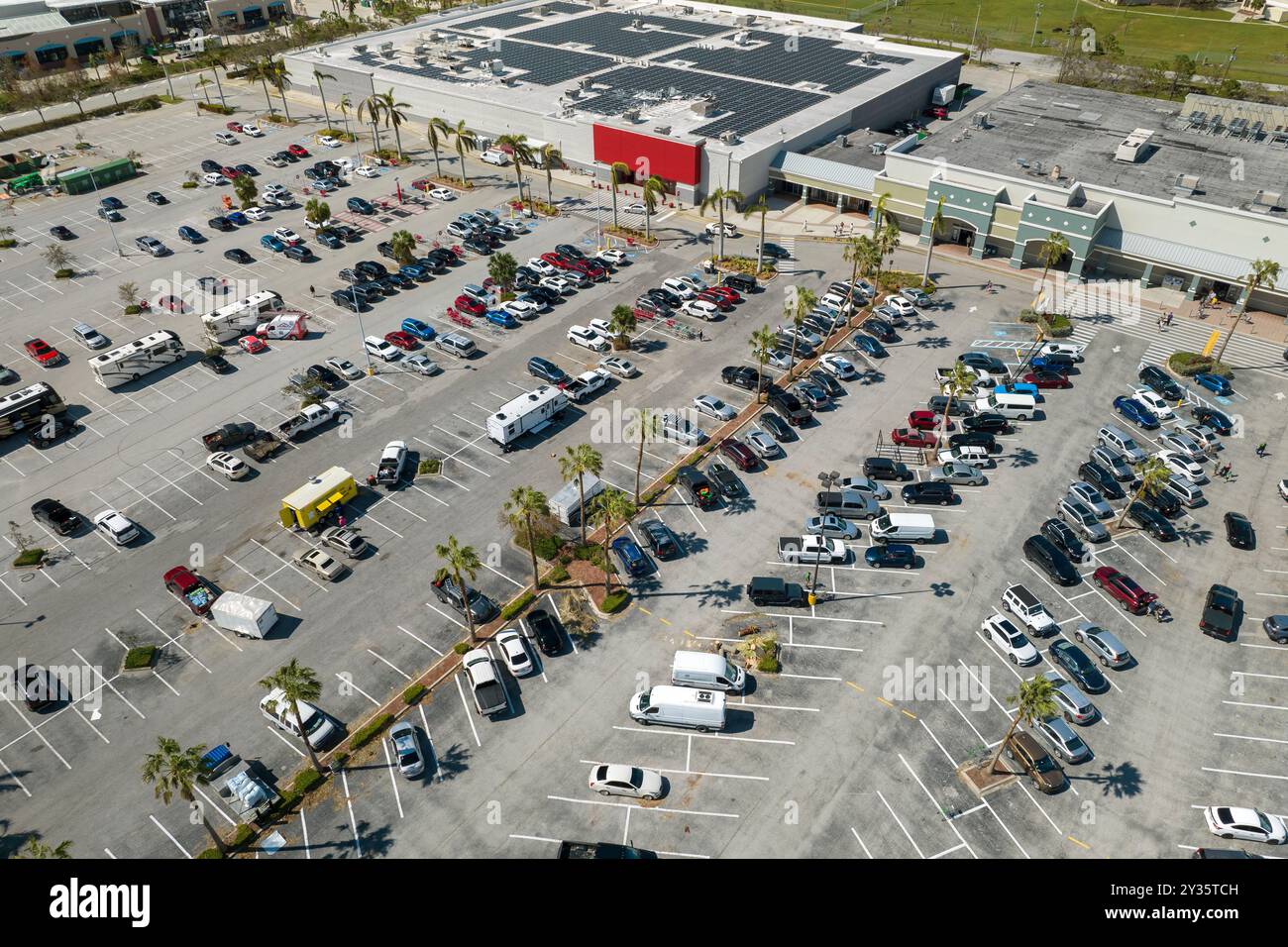 Aerial view of many cars parked on parking lot in front of a grocery ...