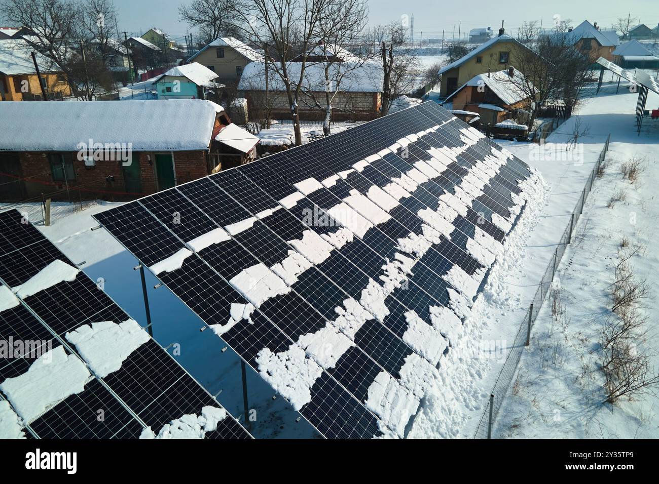 Aerial view of snow melting from covered solar photovoltaic panels at ...