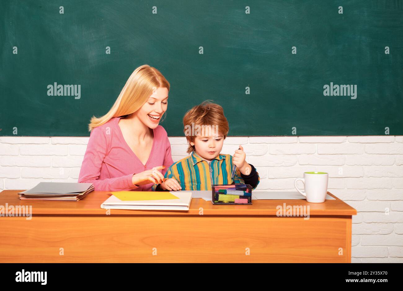 Preschool preparation. Kid little boy and teacher woman pedagogue ...