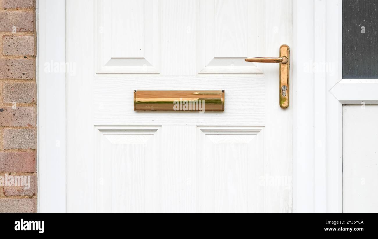 Traditional wooden English door with ornate knocker and old post box ...