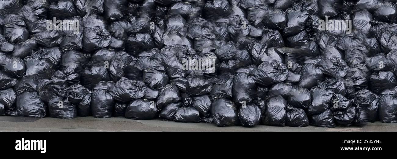 Black plastic bin bags full and left on street during bin collection ...