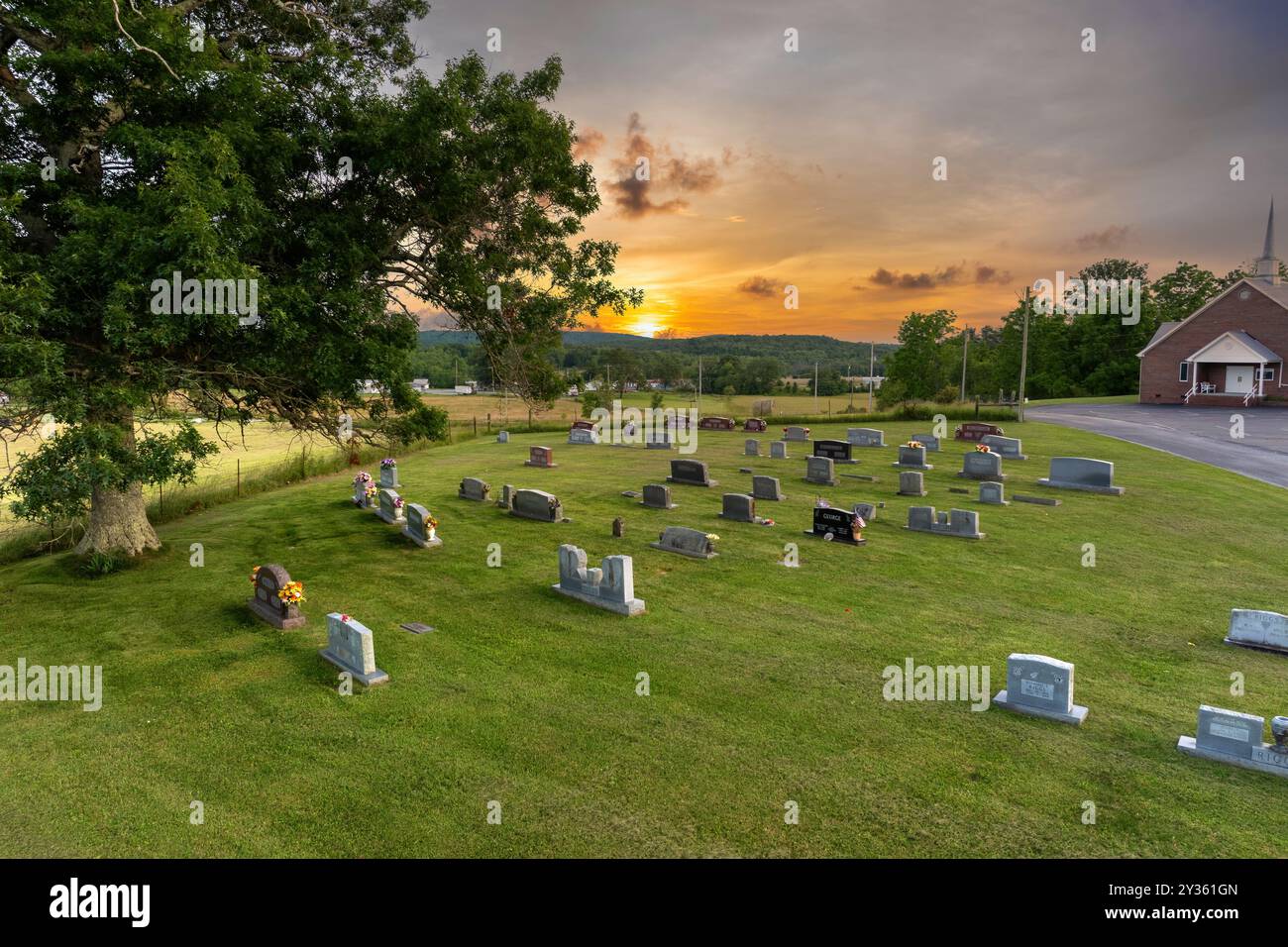 Old American cemetery with rows of tombstones on country church ...