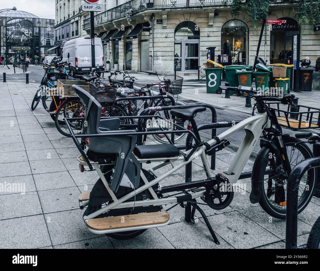 Bicycles line the bustling city streets of Bordeaux, France Stock Photo ...