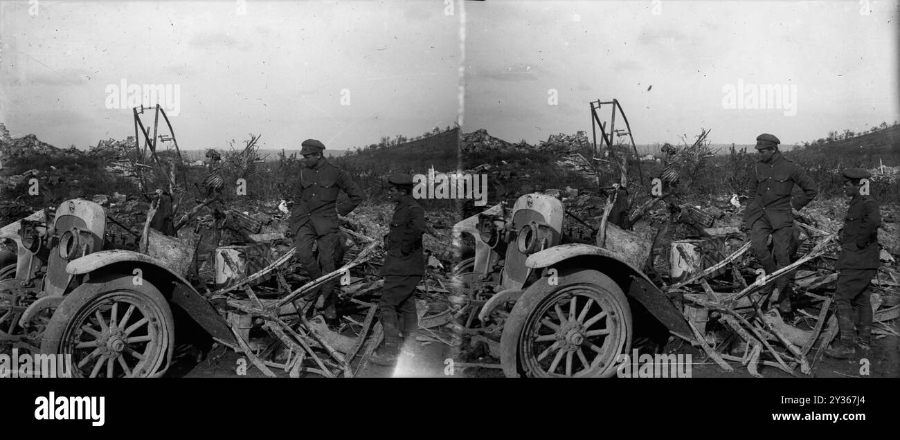 World War 1 two soldiers look at a burnt car on a road somewhere in ...