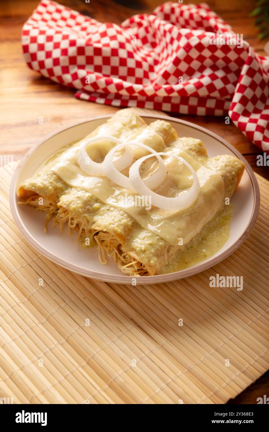 Mexican food. Enchiladas with creamy green sauce filled with shredded ...