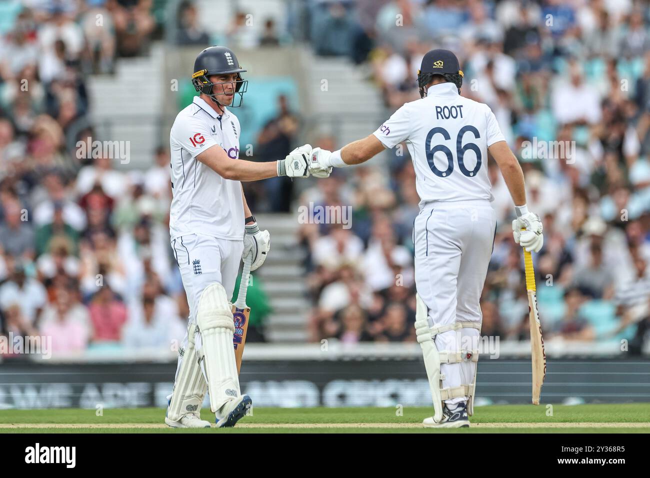 Joe Root of England fist bumps Dan Lawrence of England after he hits a ...
