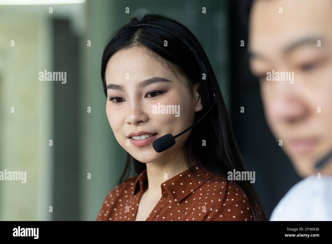 Asian business team engaged in professional work environment using ...