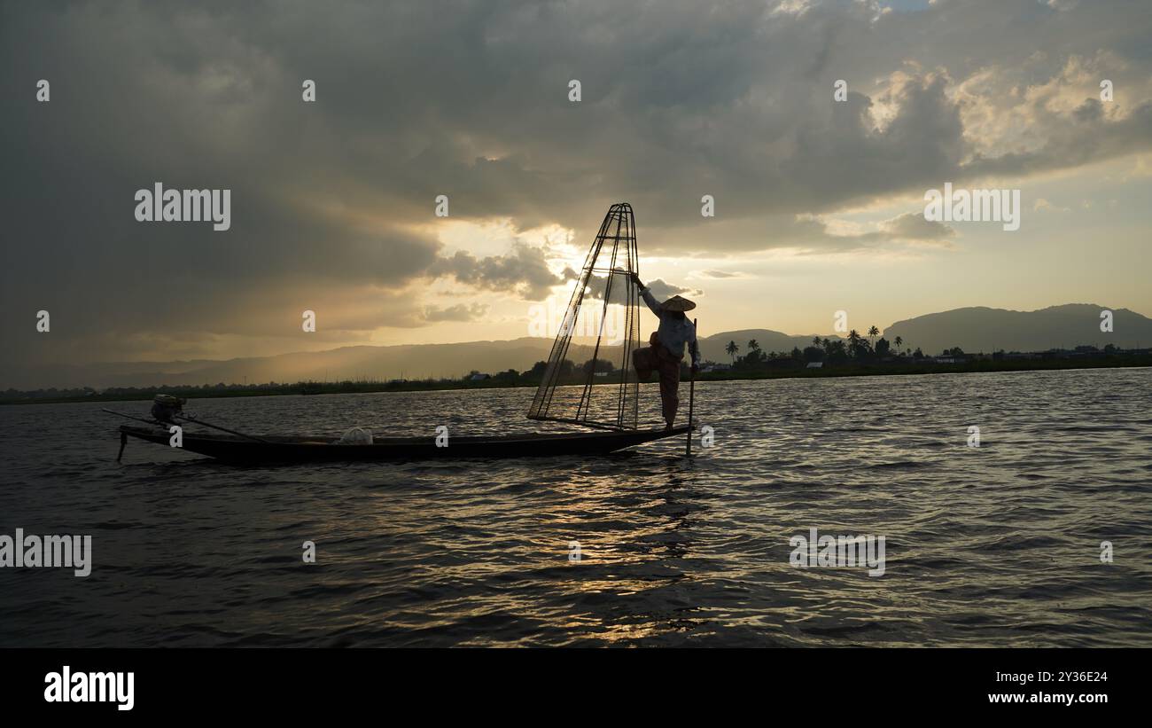 Fisherman Balancing on Boat at Inle Lake, Myanmar at Sundown Stock ...