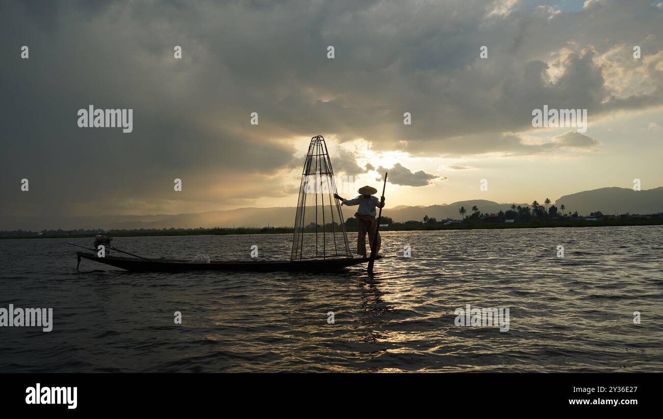 Fisherman Balancing on Boat at Inle Lake, Myanmar at Sundown Stock ...