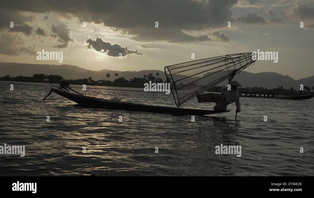 Fisherman Balancing on Boat at Inle Lake, Myanmar at Sundown Stock ...