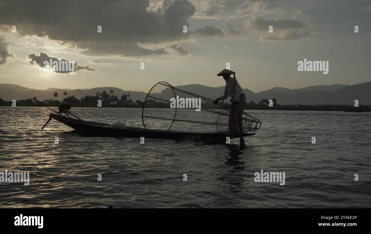 Fisherman Balancing on Boat at Inle Lake, Myanmar at Sundown Stock ...