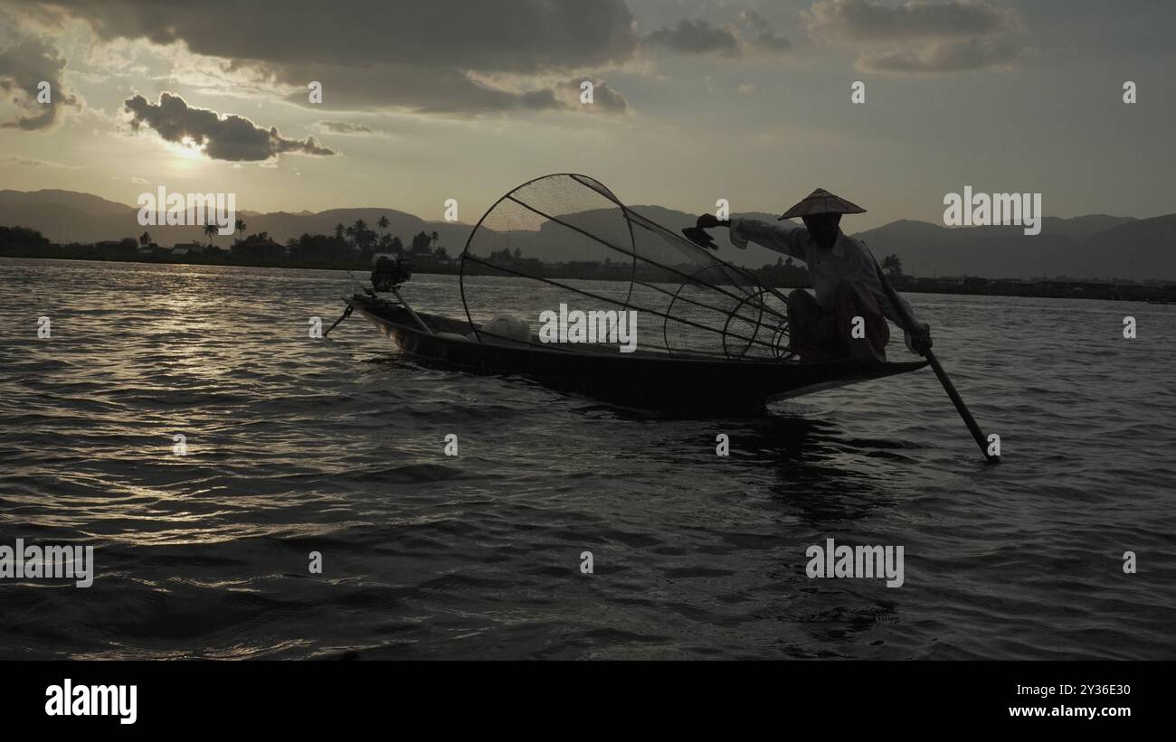 Fisherman Balancing on Boat at Inle Lake, Myanmar at Sundown Stock ...