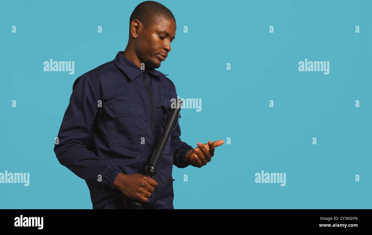 Portrait of security agent patrolling to secure assigned post, wearing ...