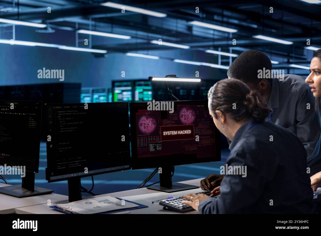 Multiethnic team of developers in server hub frightened by hacker passing firewall and stealing ...