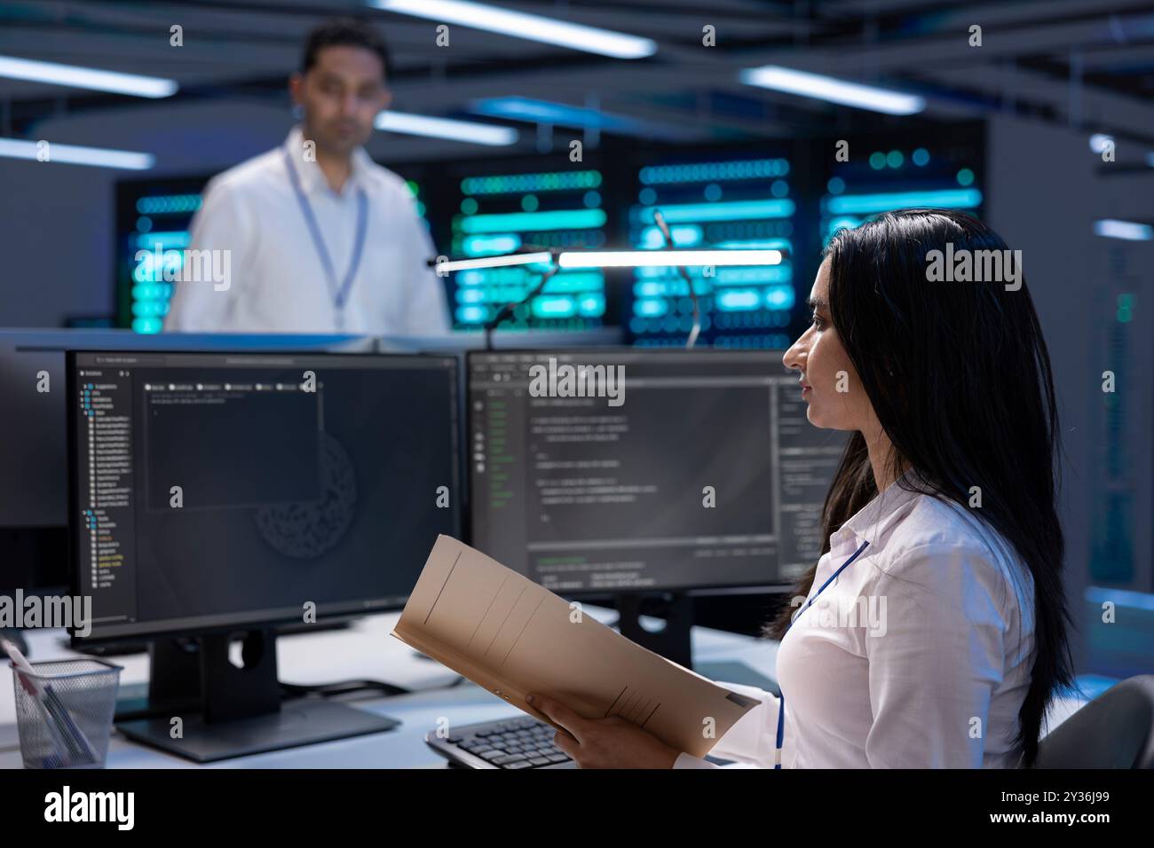 IT supervisor verifying data center gear documentation files, ensuring proper configurations and ...