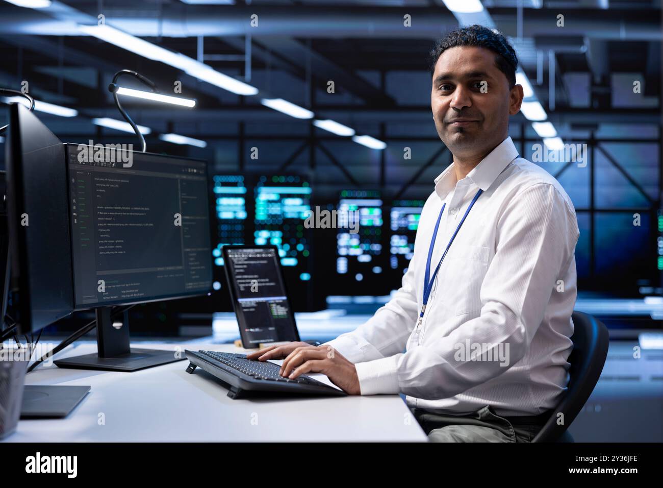 Portrait Of Smiling Engineer Checking Event Logs On Computer To Find Out Of Order Data Center