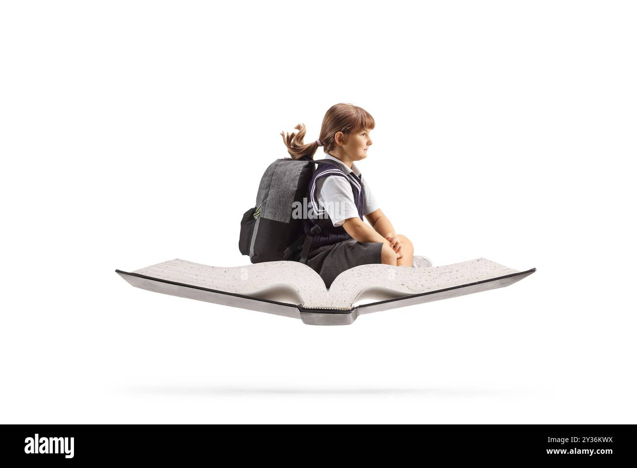 Child sitting on a book and floating in the air isolated on white ...