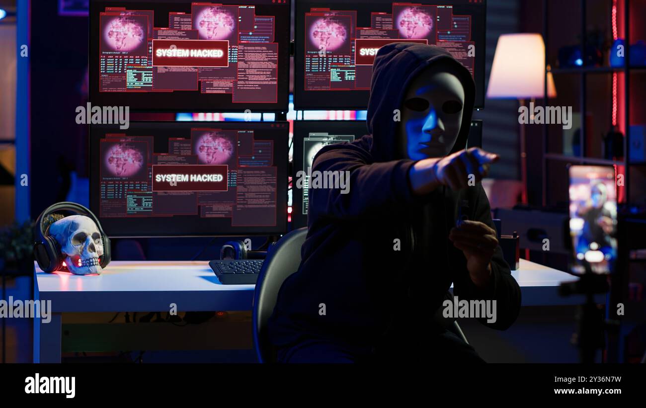 Evil programmer concealing identity using mobile phone to film ransom ...