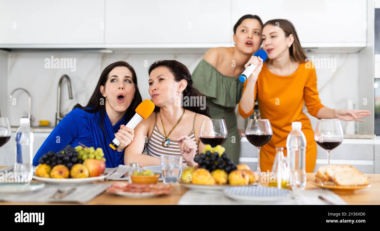Group of women friends singing karaoke Stock Photo - Alamy