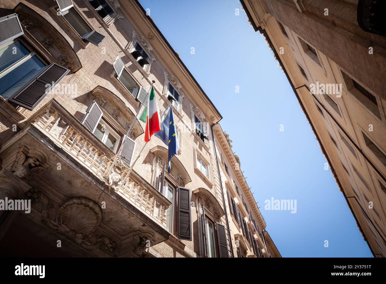 Italian & European Union flags in a typical narrow street in old Rome ...