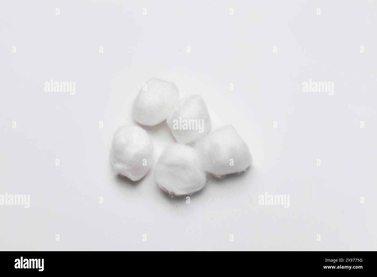 Balls of fluffy white cotton wool against a white background Stock ...