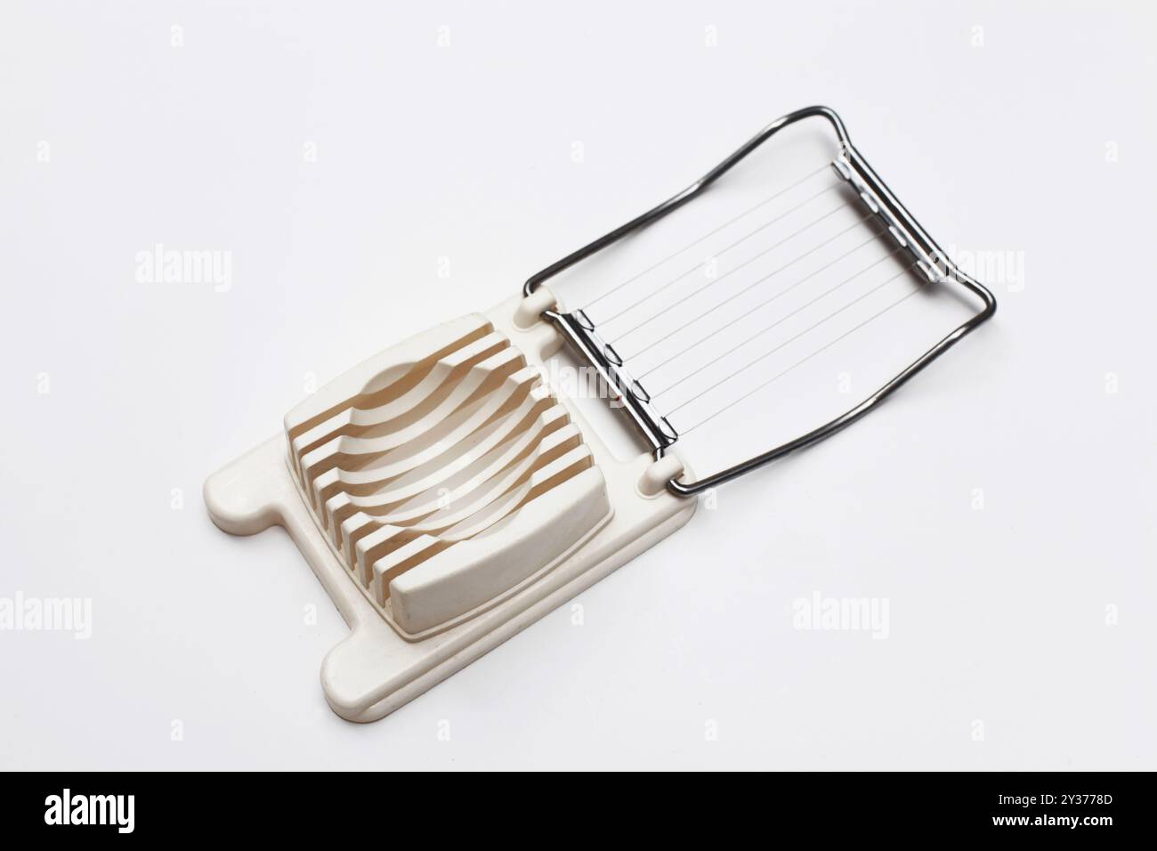 Egg Slicer kitchen utensil on white background Stock Photo - Alamy