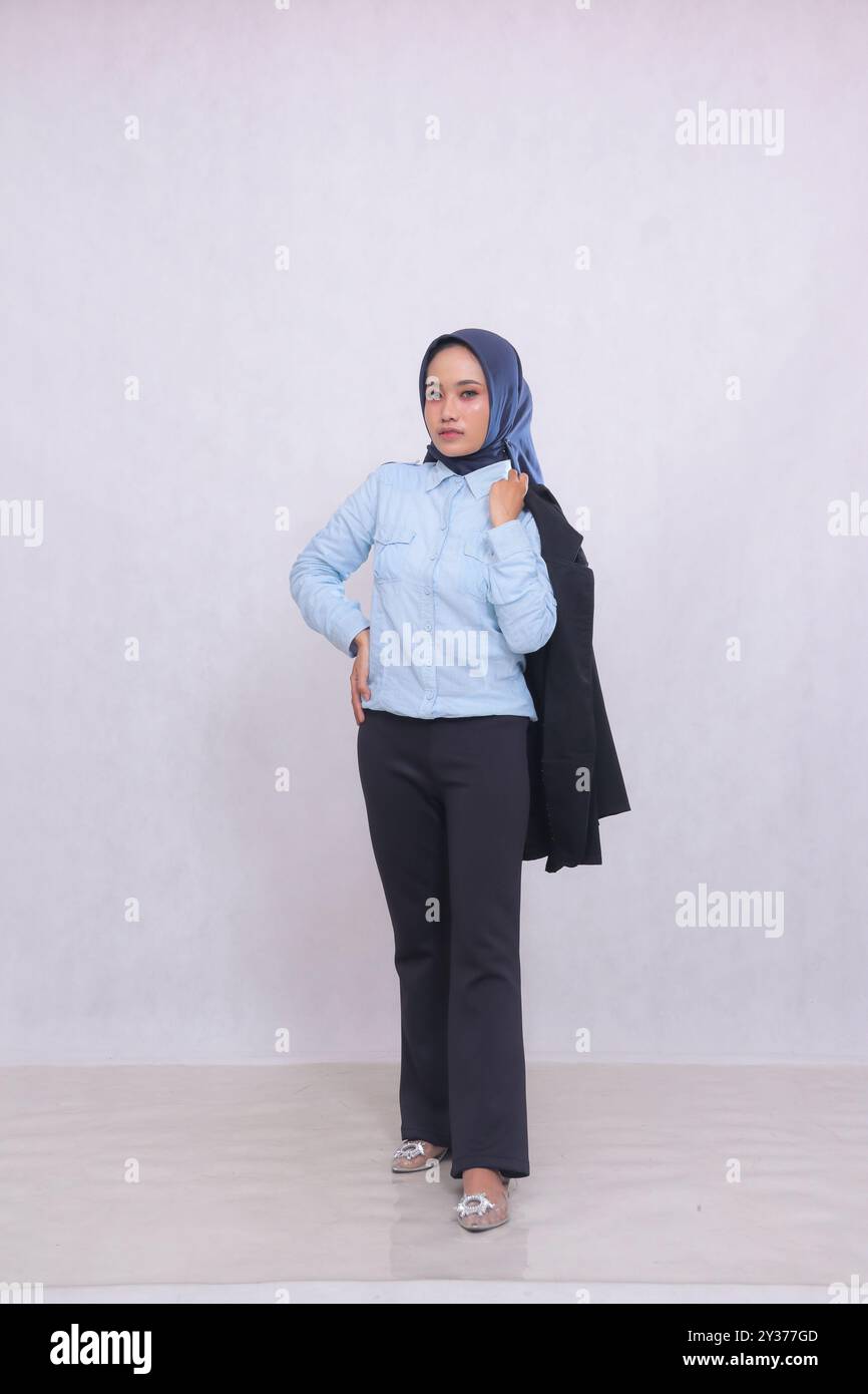 full body mature Asian office woman wearing a hijab blue shirt standing ...