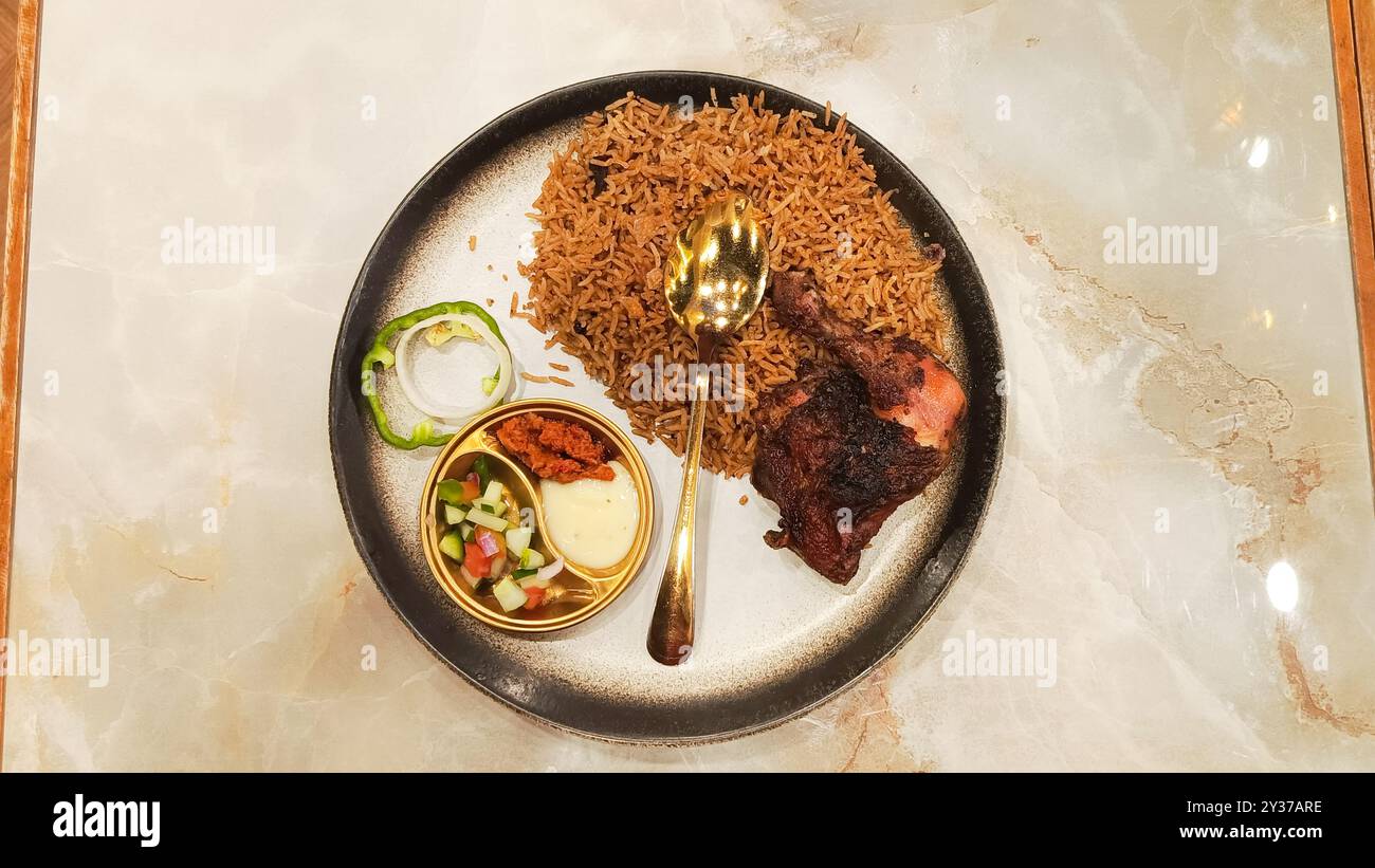 portrait flat lay nasi kebuli (kebuli rice) in the middle, typical ...